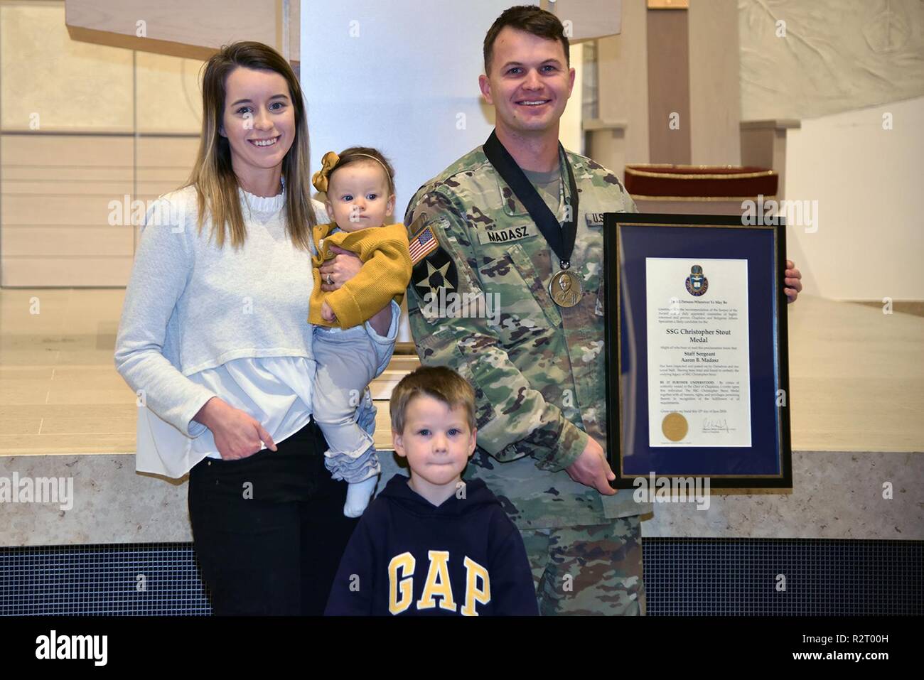 Staff. Sgt. Aaron Madasz, 2nd Cavalry Regiment, stands with his family ...