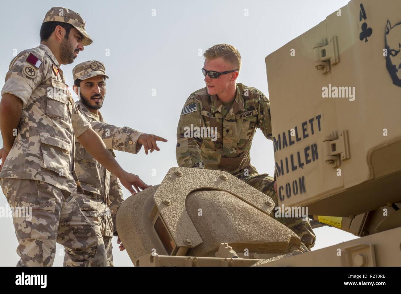 UM HATTAH, Qatar – Qatari soldiers (left) discuss the capabilities of a ...