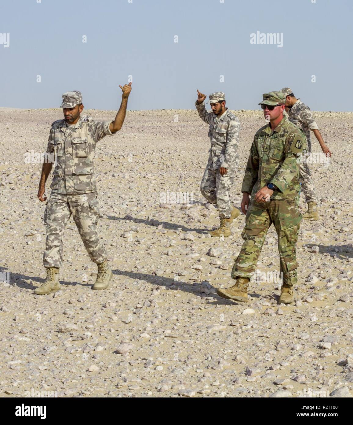 UM HATTAH, Qatar – Qatari soldiers signal and move into a different ...