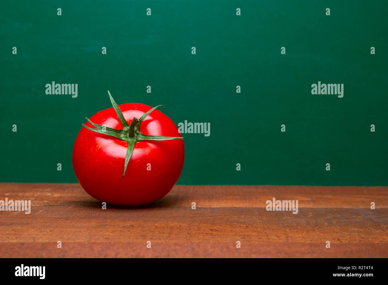 Whole Red Tomato On A Wooden Table. Green Background. Organic Food ...