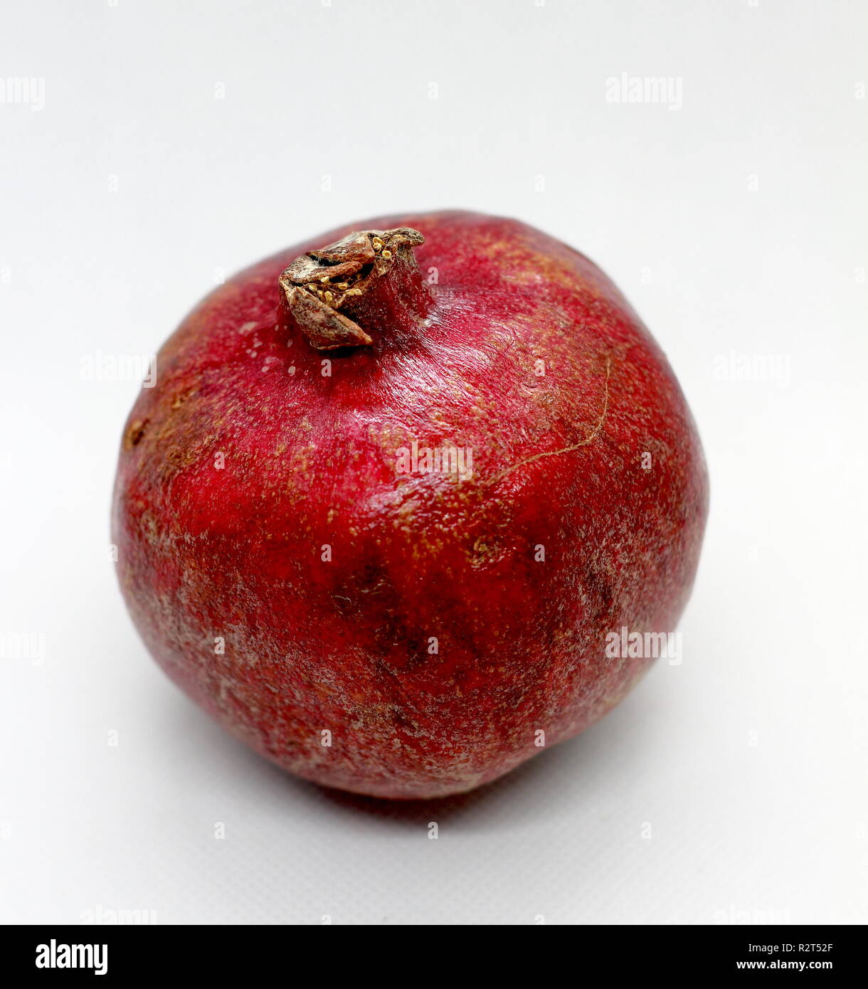 Ripe organic pomegranate on white background. Close up big fresh ...