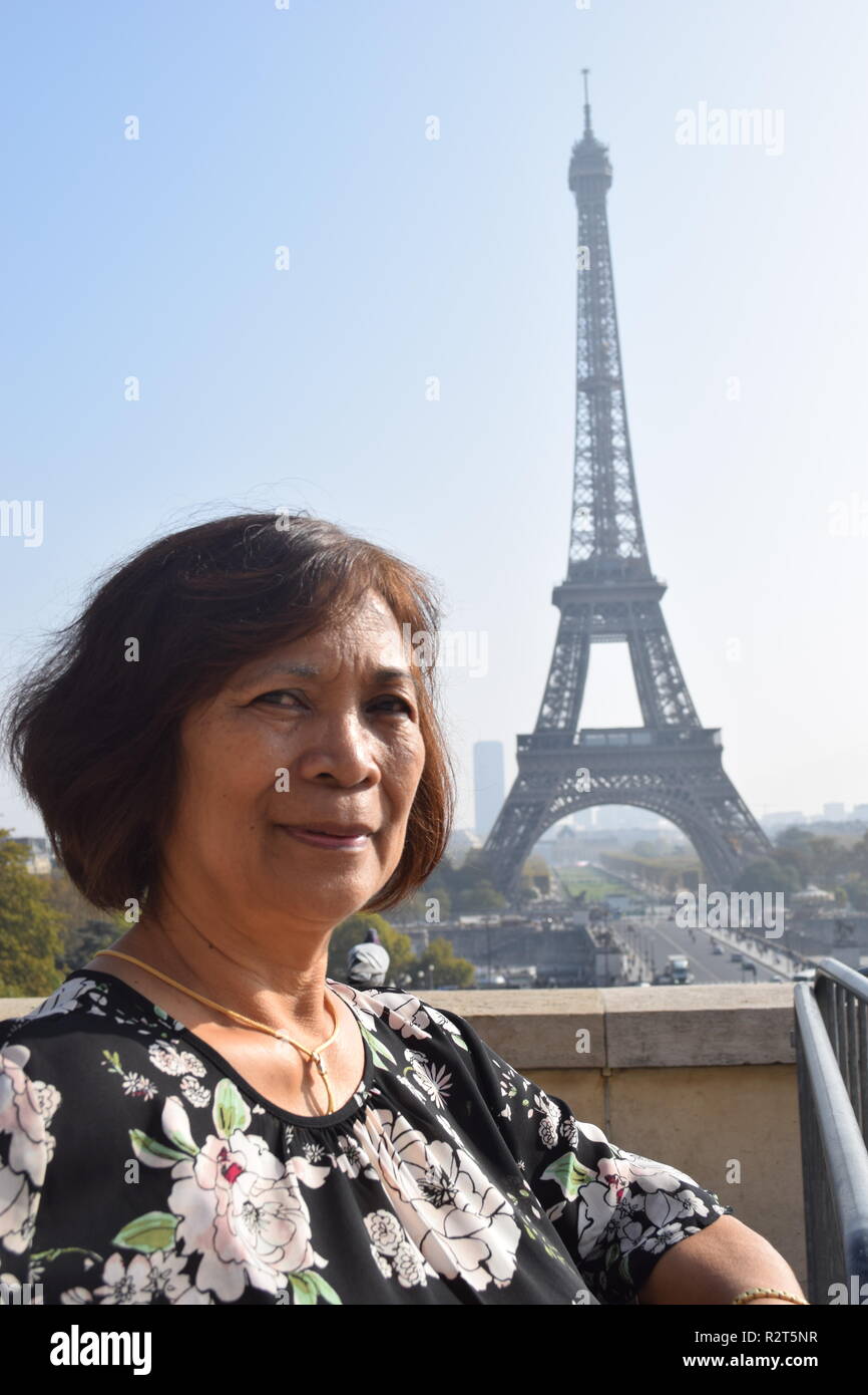 Senior citizen taken an iconic view with the Eiffel Tower in the ...