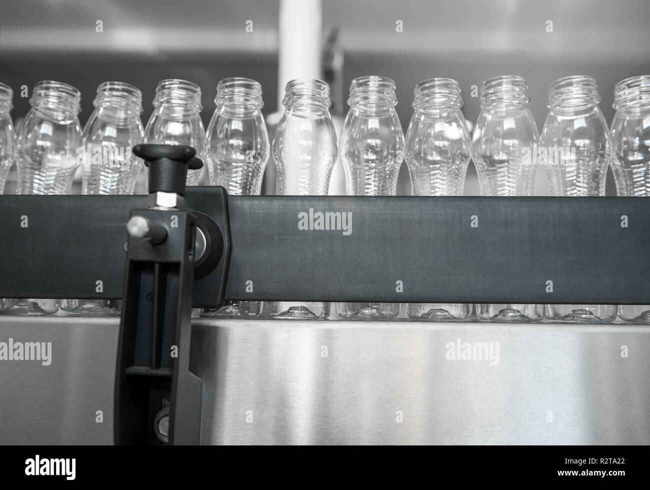 empty plastic bottles on conveyor belt. equipment at the dairy plant ...