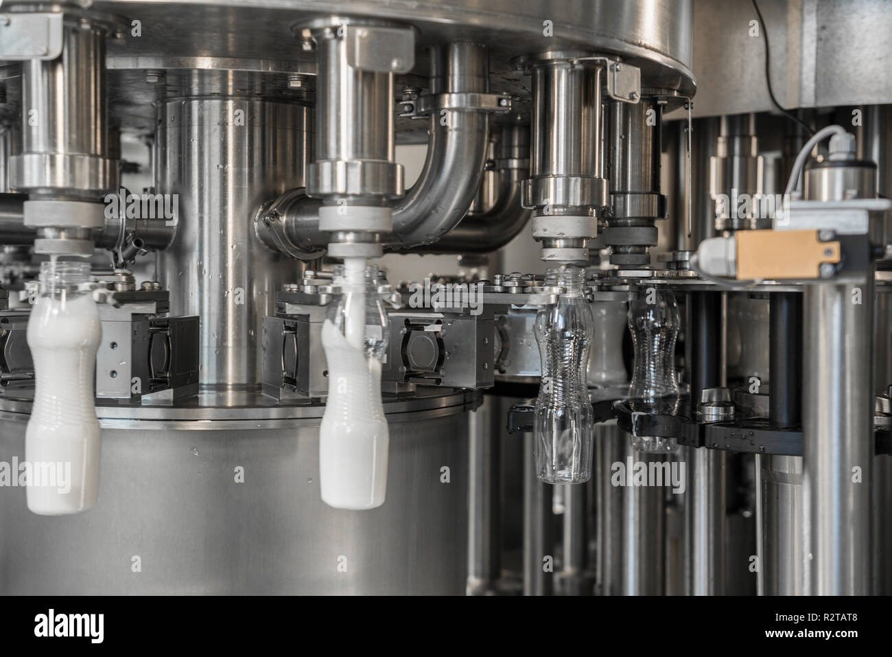 filling milk in to plastic bottles at the factory. equipment at the ...