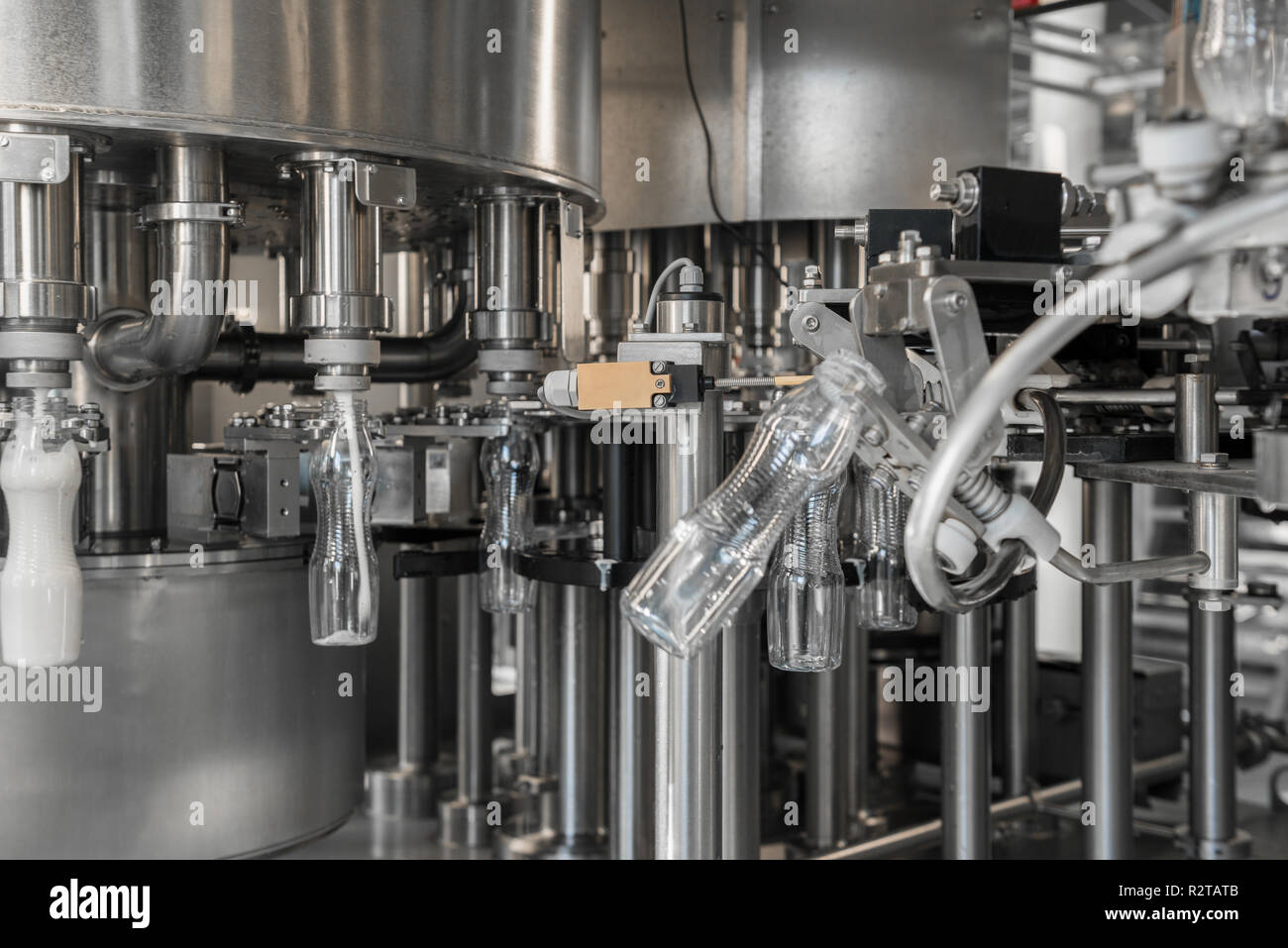 filling milk in to plastic bottles at the factory. equipment at the ...