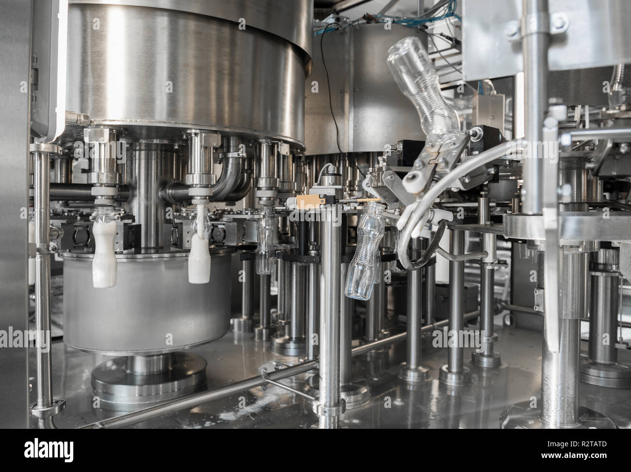 filling milk in to plastic bottles at the factory. equipment at the ...