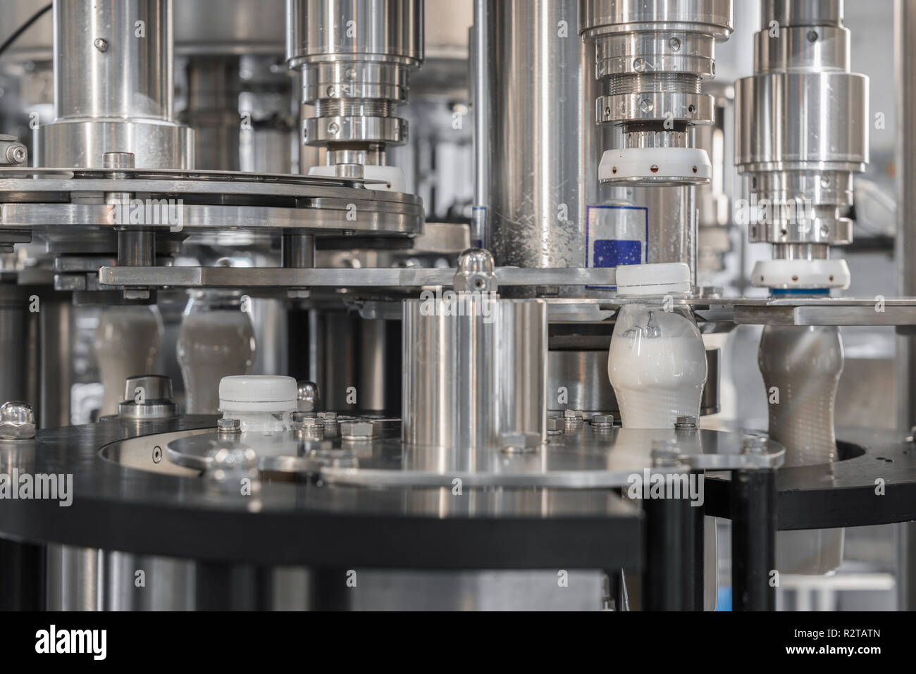 filling milk in to plastic bottles at the factory. equipment at the ...