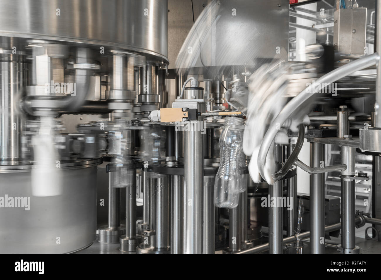 filling milk in to plastic bottles at the factory. equipment at the ...