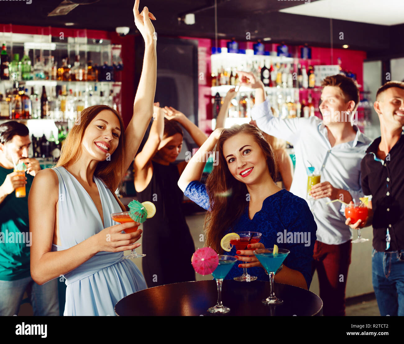 Two happy women are drinking cocktails on corporate party Stock Photo ...