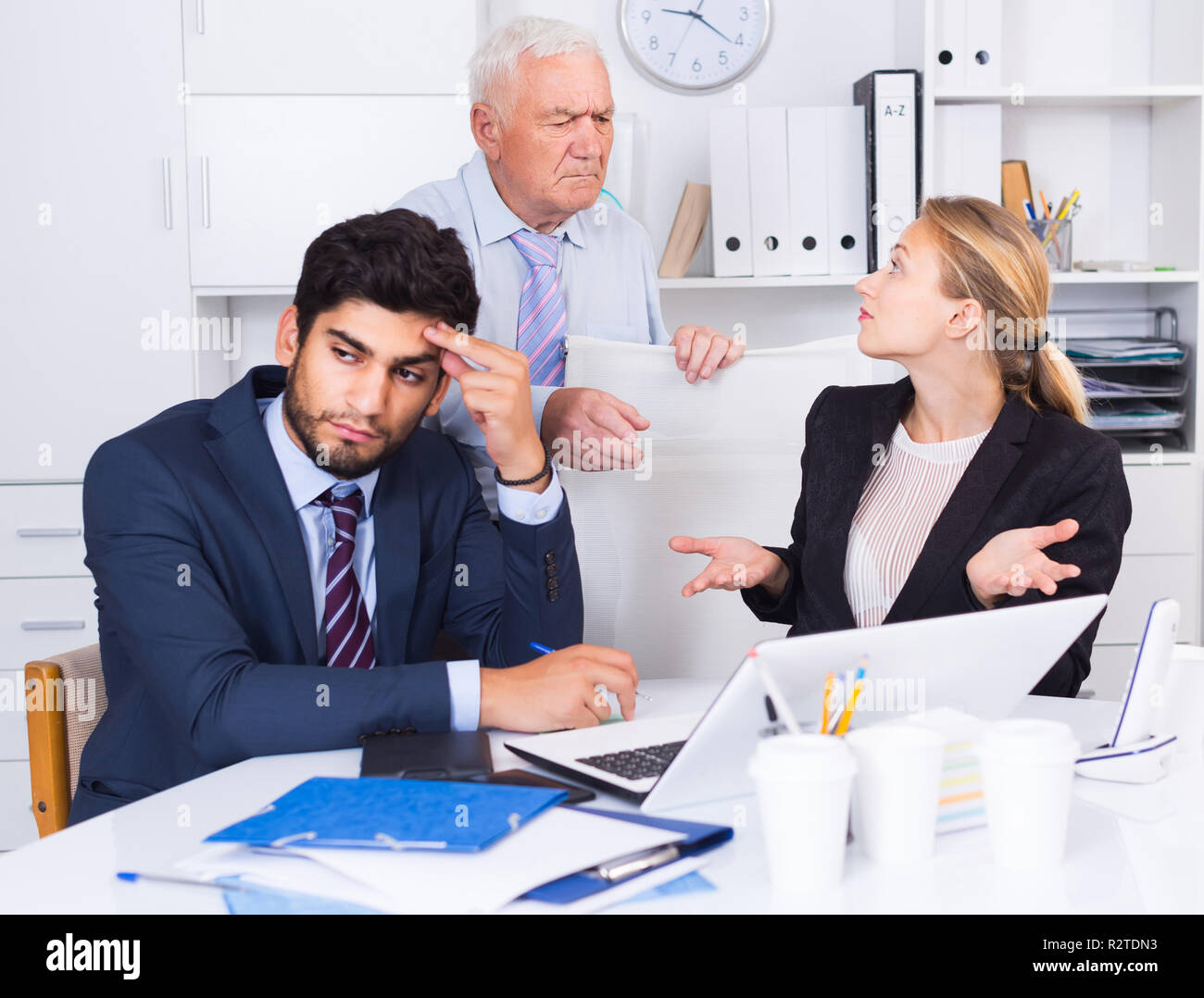 Mature businessman is chastising employees because of uncompleted work ...