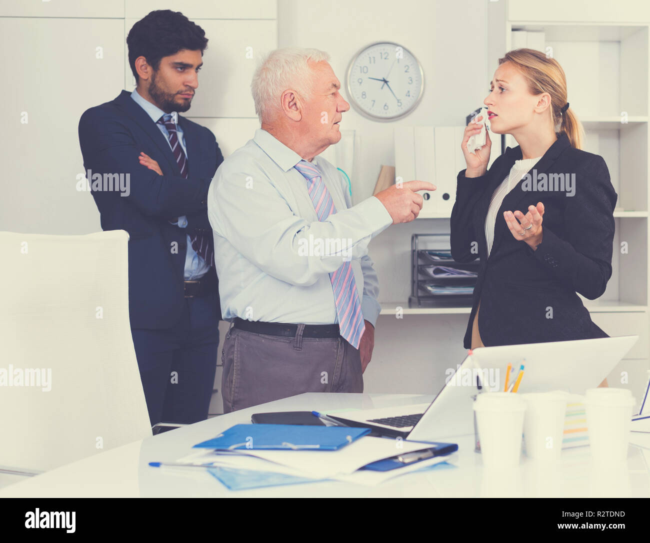Mature businessman is chastising employees because of uncompleted work ...