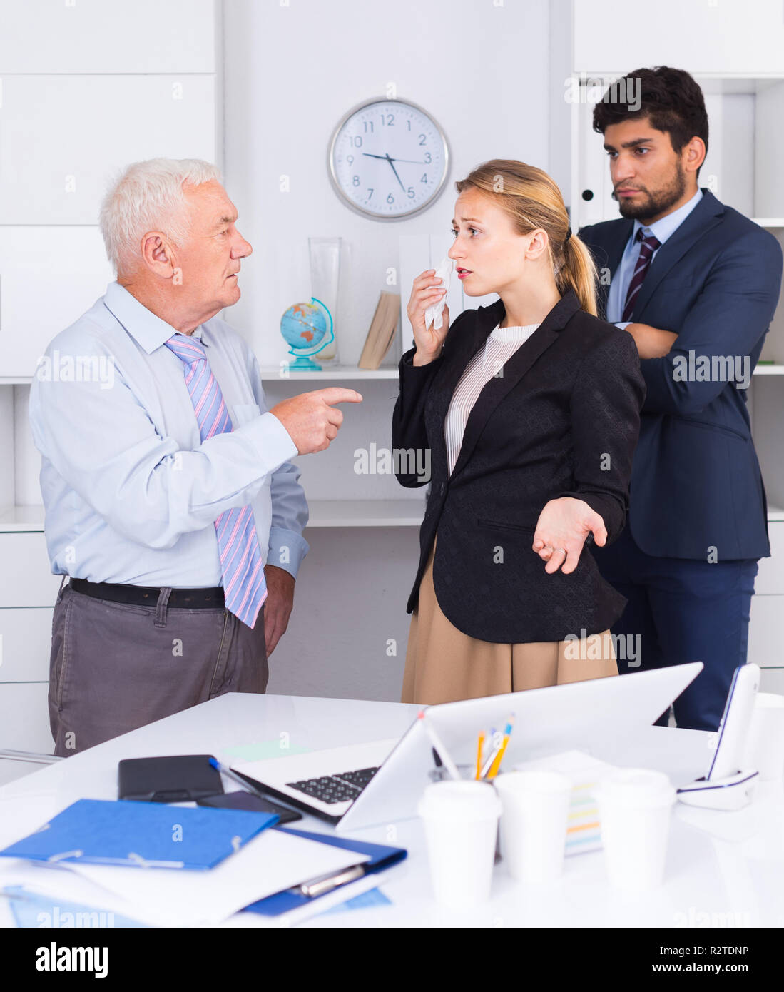 Mature businessman is chastising employees because of uncompleted work ...