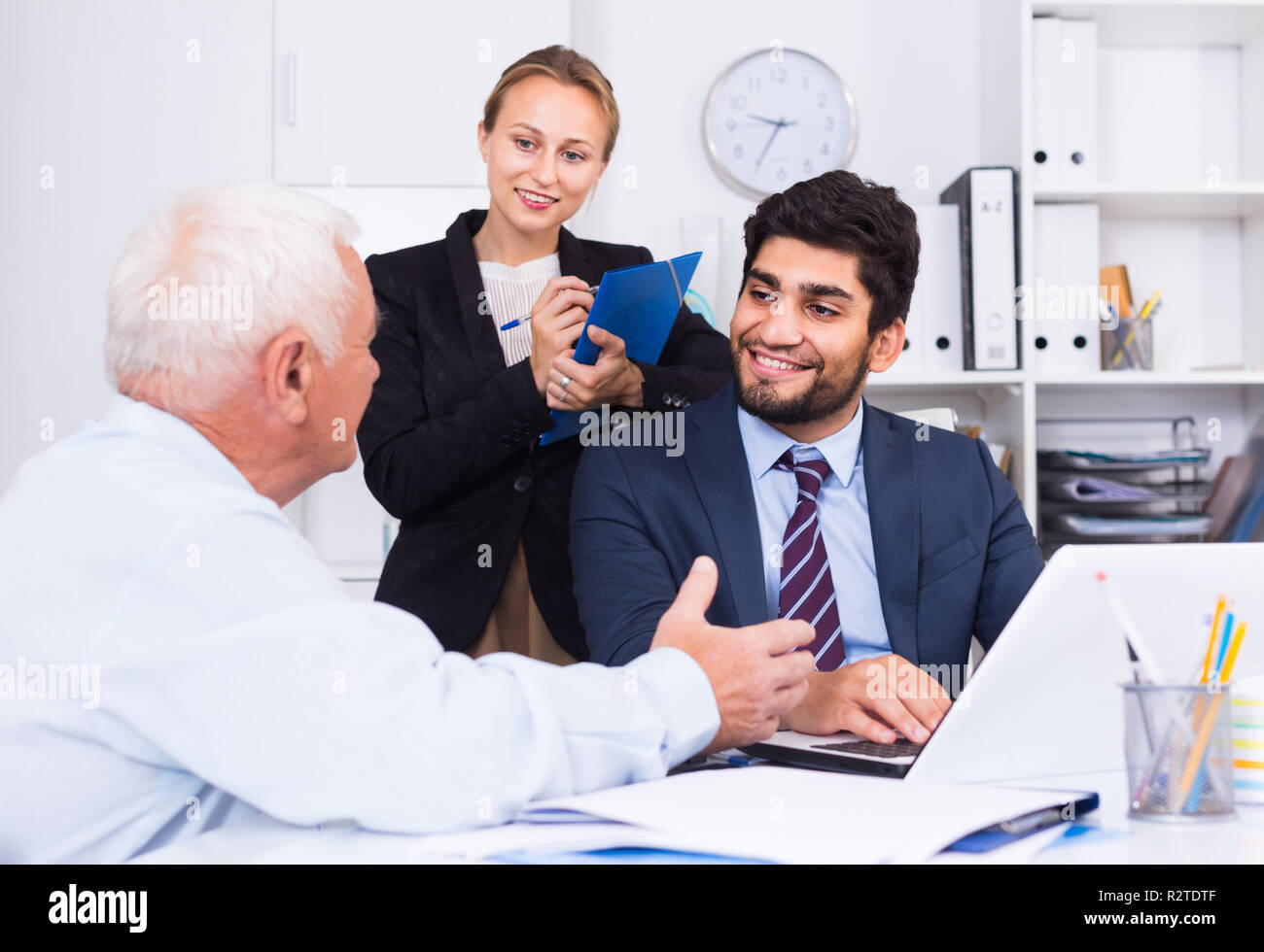 Old man is talking to colleague, while the secretary writing important ...