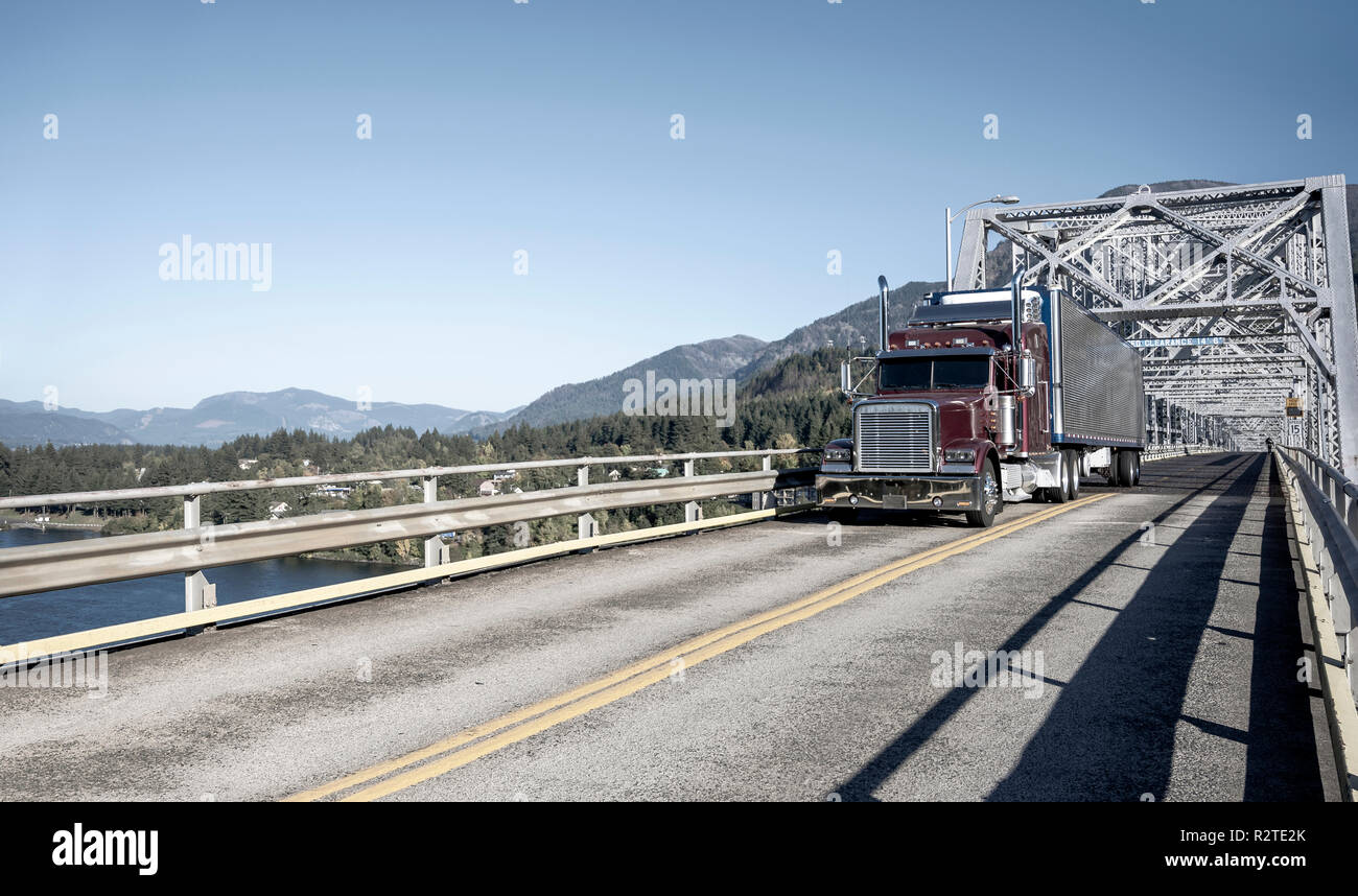 Classic American bonnet big rig burgundy semi truck with shiny ...