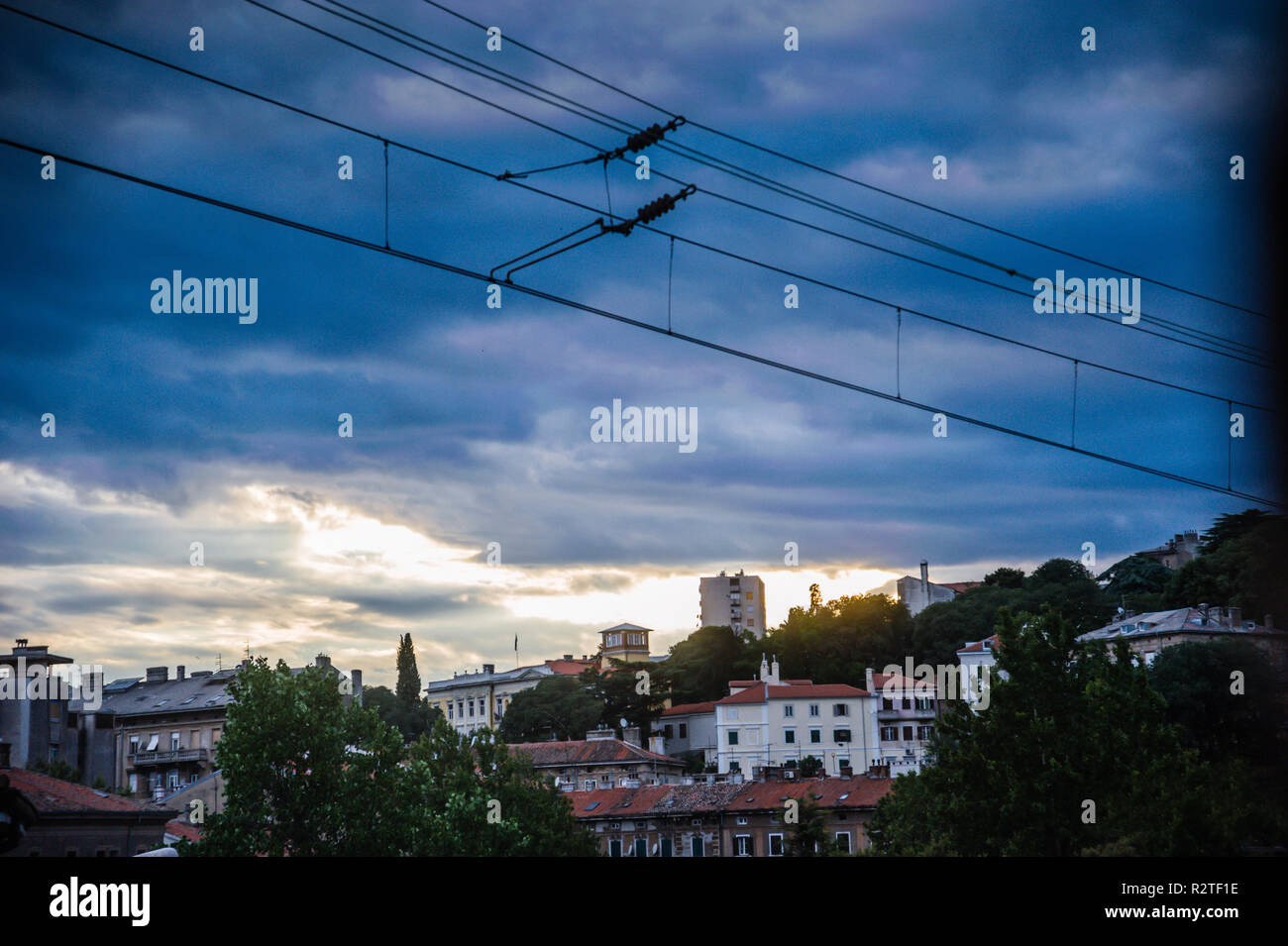 Electrical wires with city scape in background at the sunset, Rijeka ...