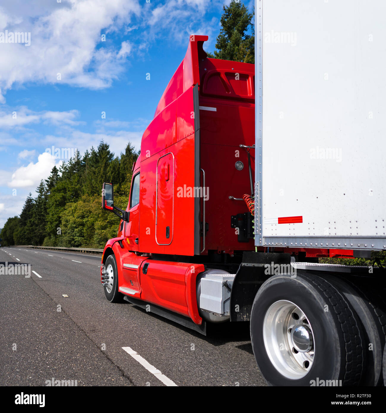 Bright red bonnet American modern long haul big rig semi truck with ...