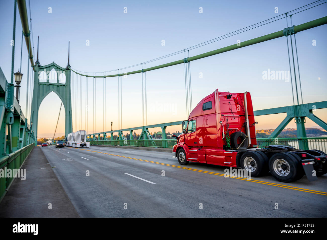 Bright red bonnet big rig semi truck tractor with high cab running on ...