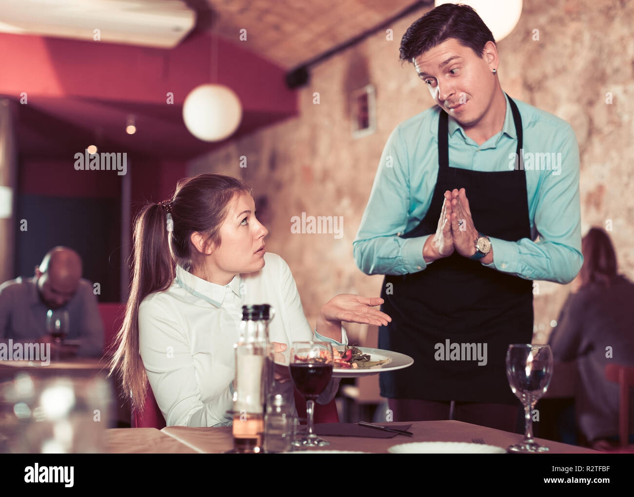 Female client expressing displeasure with food talking to excusing ...