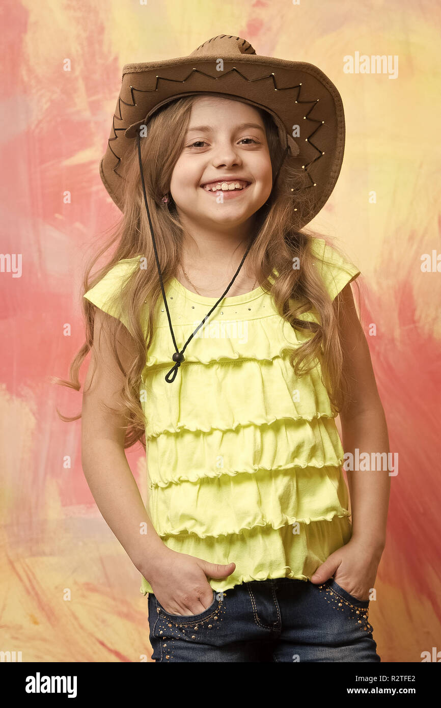 child, little smiling girl in cowboy hat on colorful background Stock ...