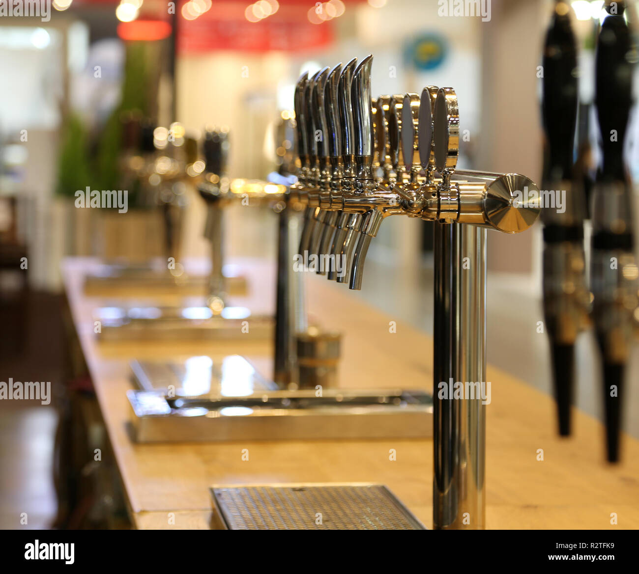 many draft beer taps on the counter of a pub Stock Photo - Alamy