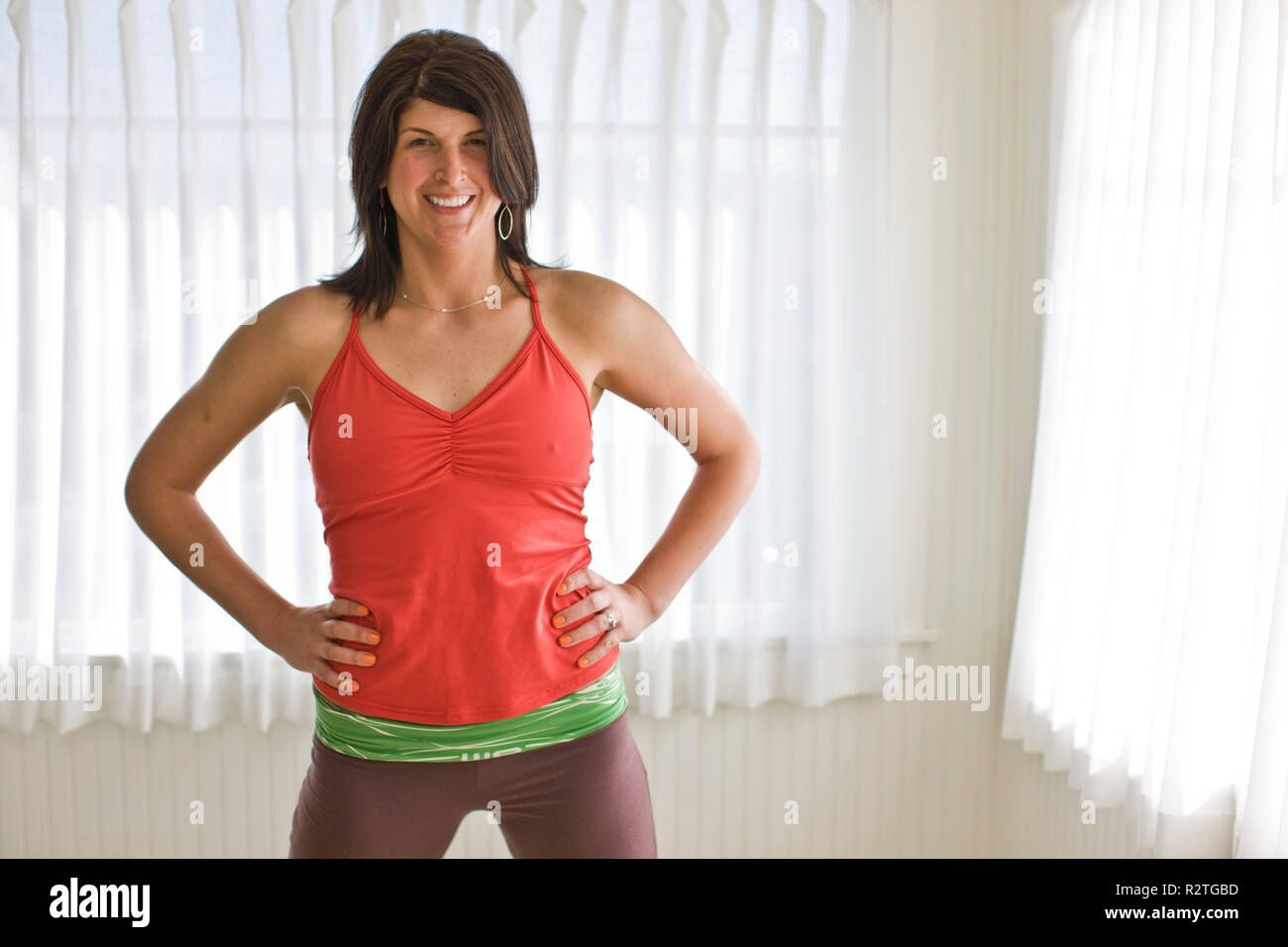 Half length smiling hands on hips hi-res stock photography and images ...