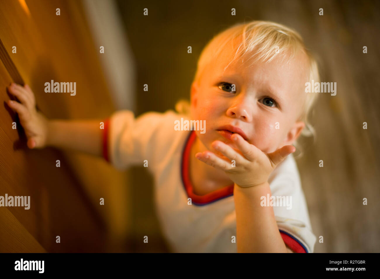 Toddler with his hand on his chin Stock Photo - Alamy