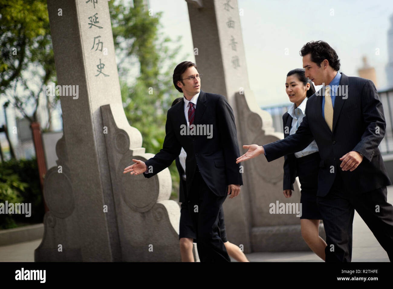 Three business colleagues having a discussion while walking through the ...
