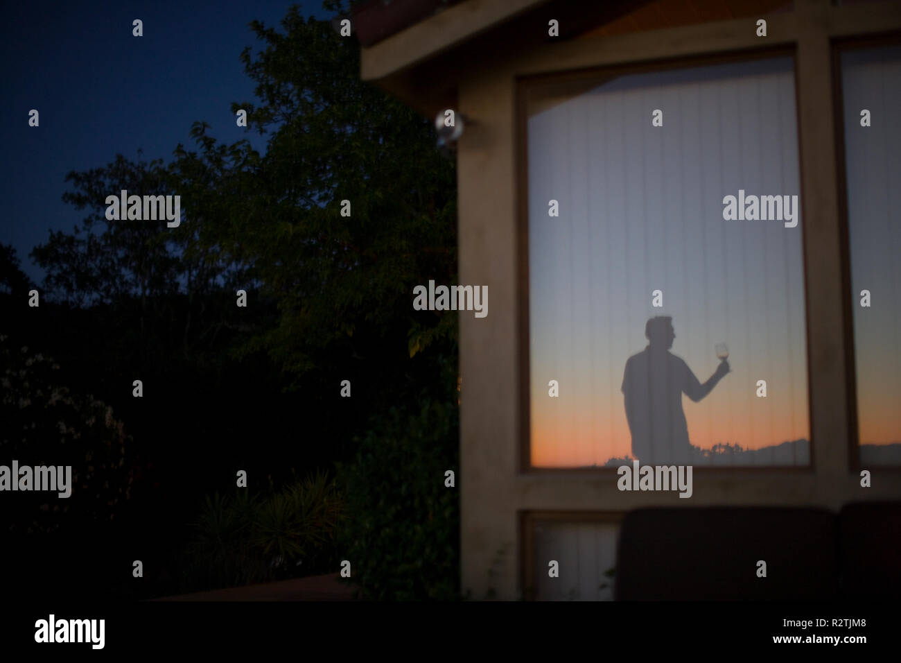 Reflection of a person in a window at twilight Stock Photo - Alamy
