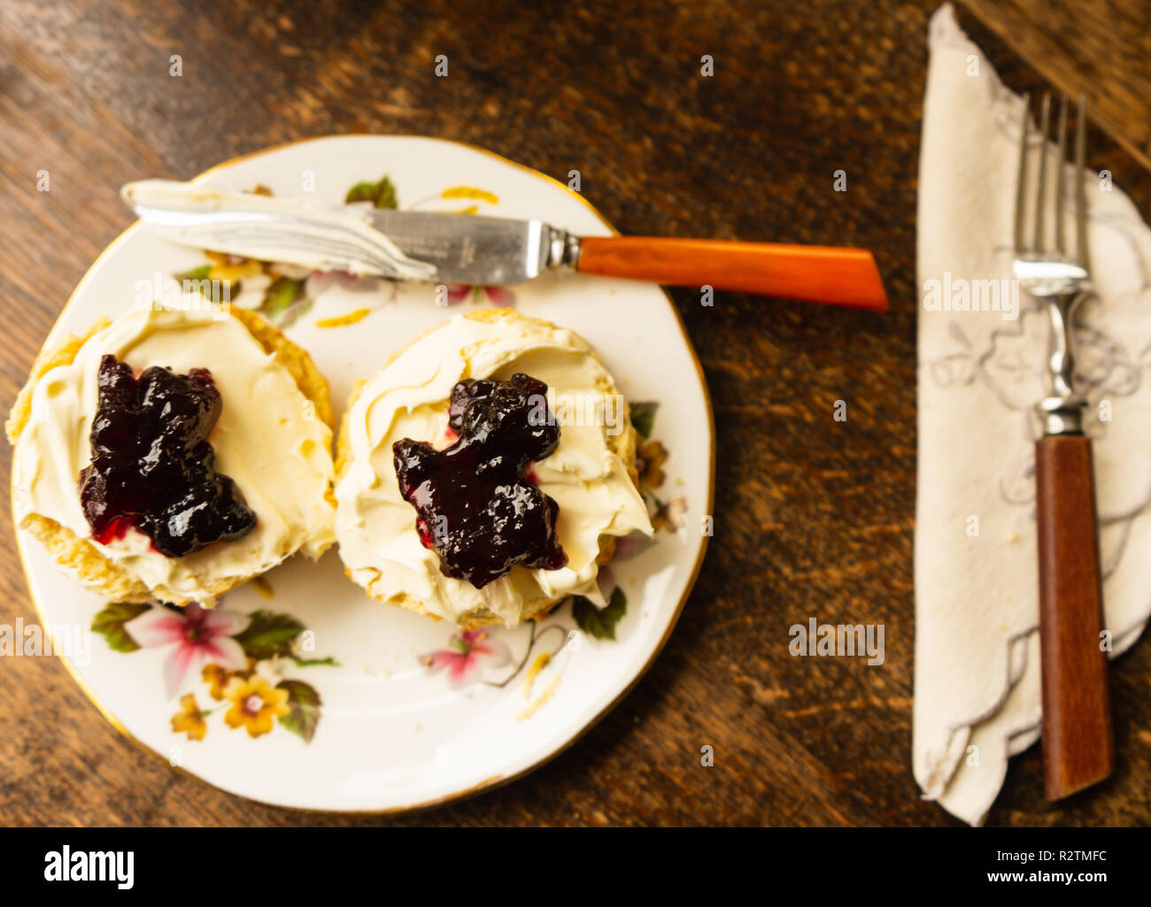 Traditional British scone with clotted cream and jam from above Stock ...