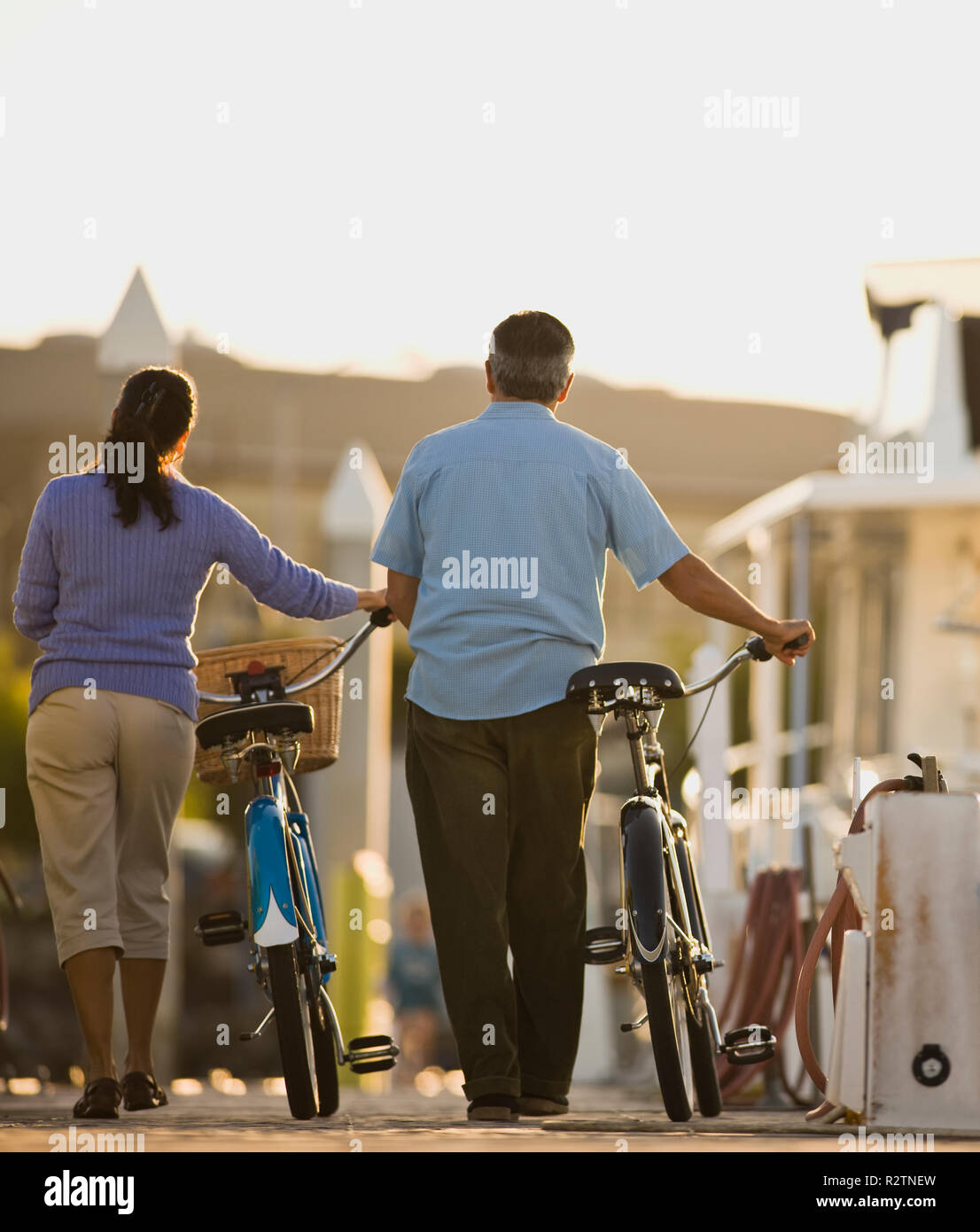 Mature man and wife pushing their bicycles together Stock Photo - Alamy