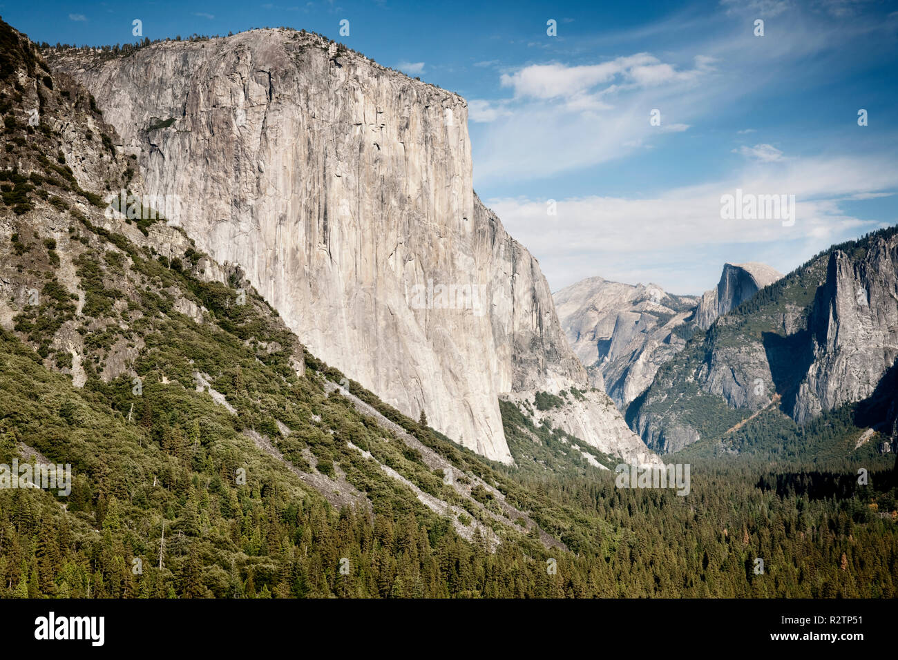 Cliff faces and tree covered valley Stock Photo - Alamy