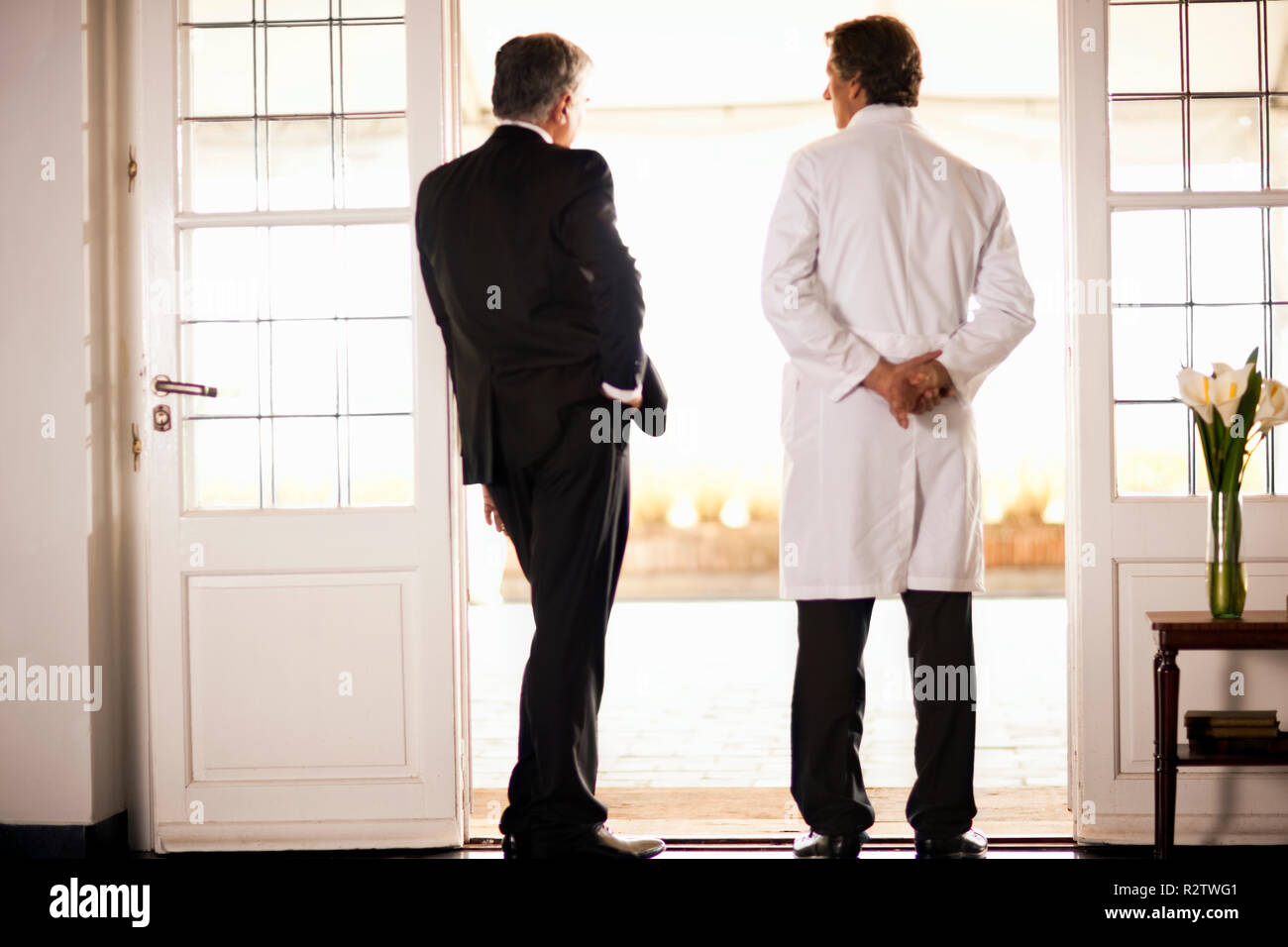 Rear view of two male doctors talking Stock Photo - Alamy