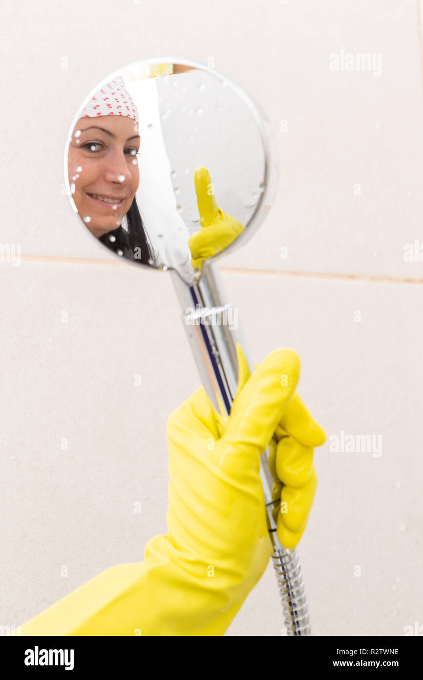 Reflection of woman wearing bandana showing thumb up as like gesture in ...