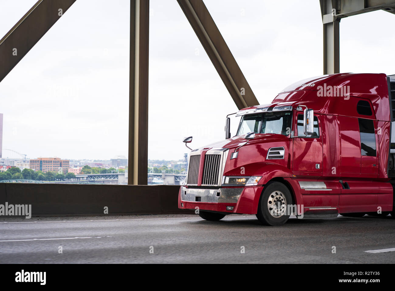 Bright pearl red modern big rig semi truck with geometric shape and ...