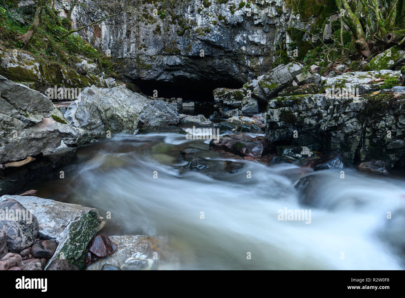 River flowing into a cave Stock Photo - Alamy
