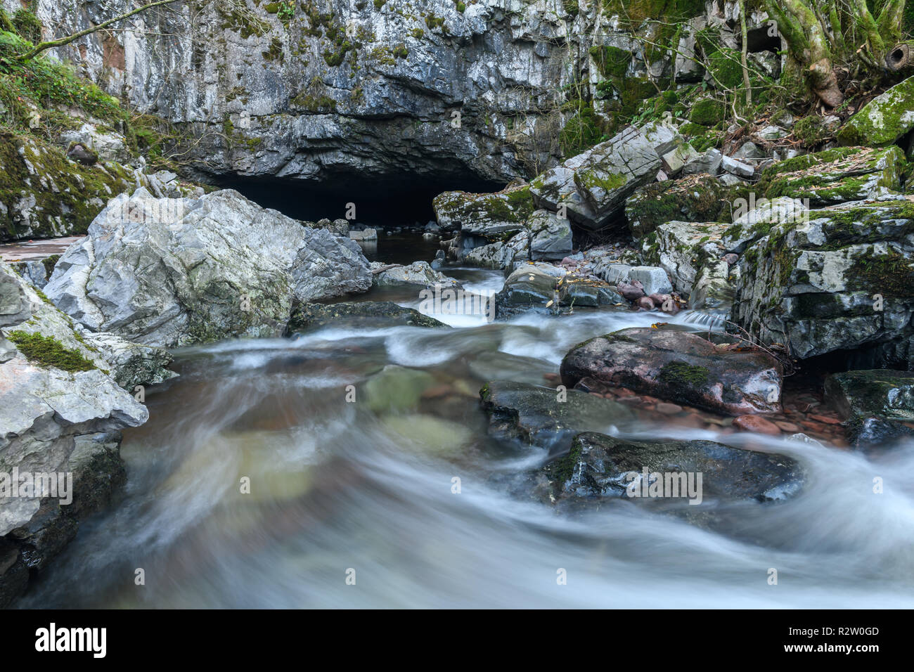 River flowing into a cave Stock Photo - Alamy