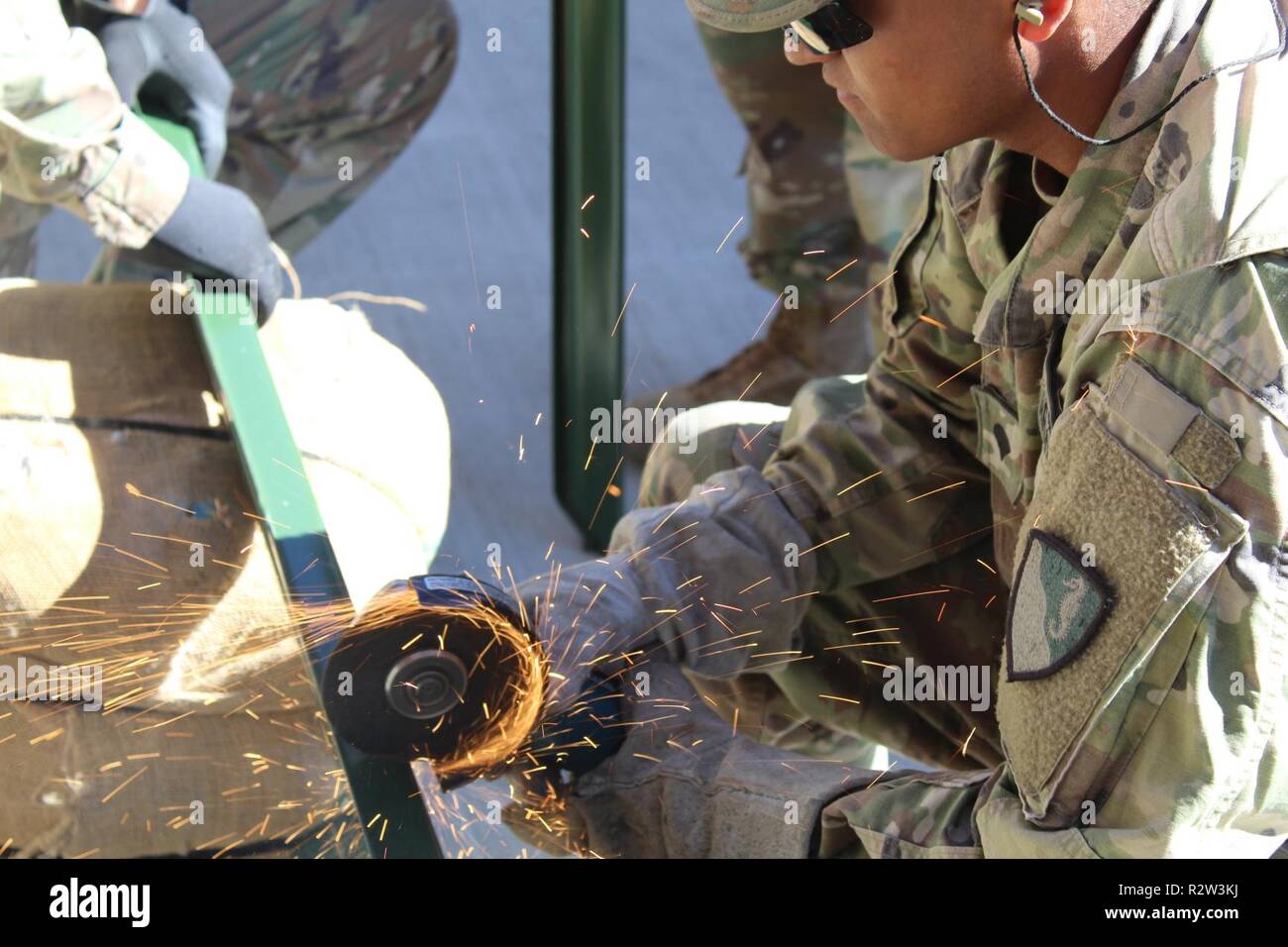 Spc. Alex Alvarez, 104th Engineer Construction Company, cuts a metal ...