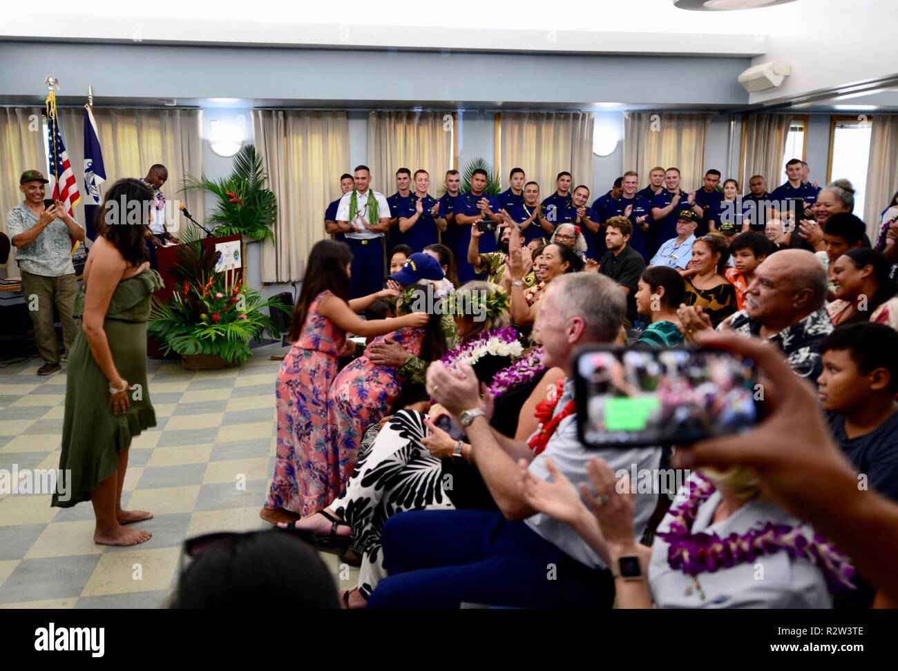 Mitchell Lani's daughter Pasha looks on as his grandaughters hug him ...