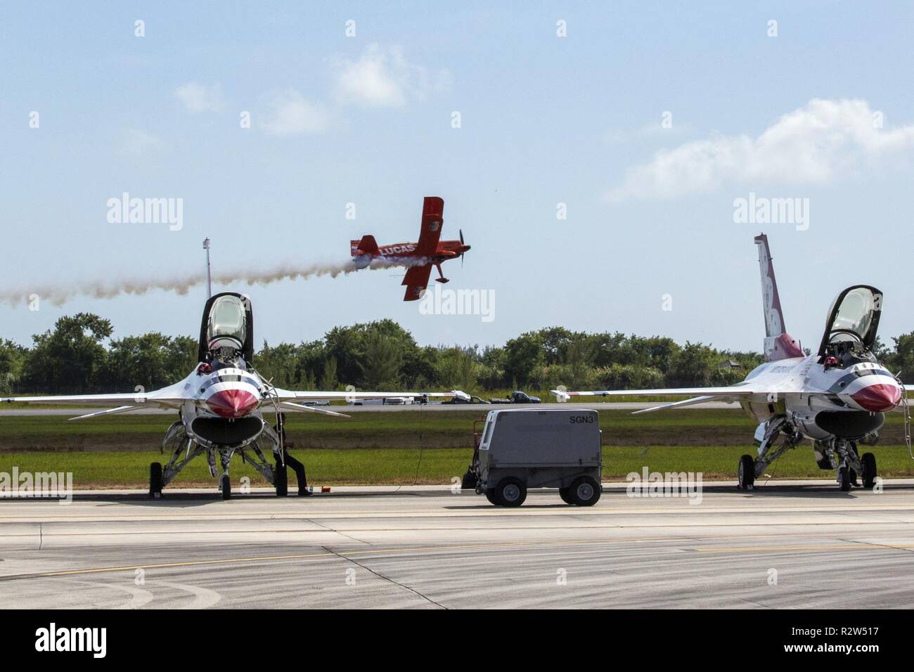 Mike Wiskus flies a Pitts S-1-11B past the U.S. Air Force Thunderbirds ...