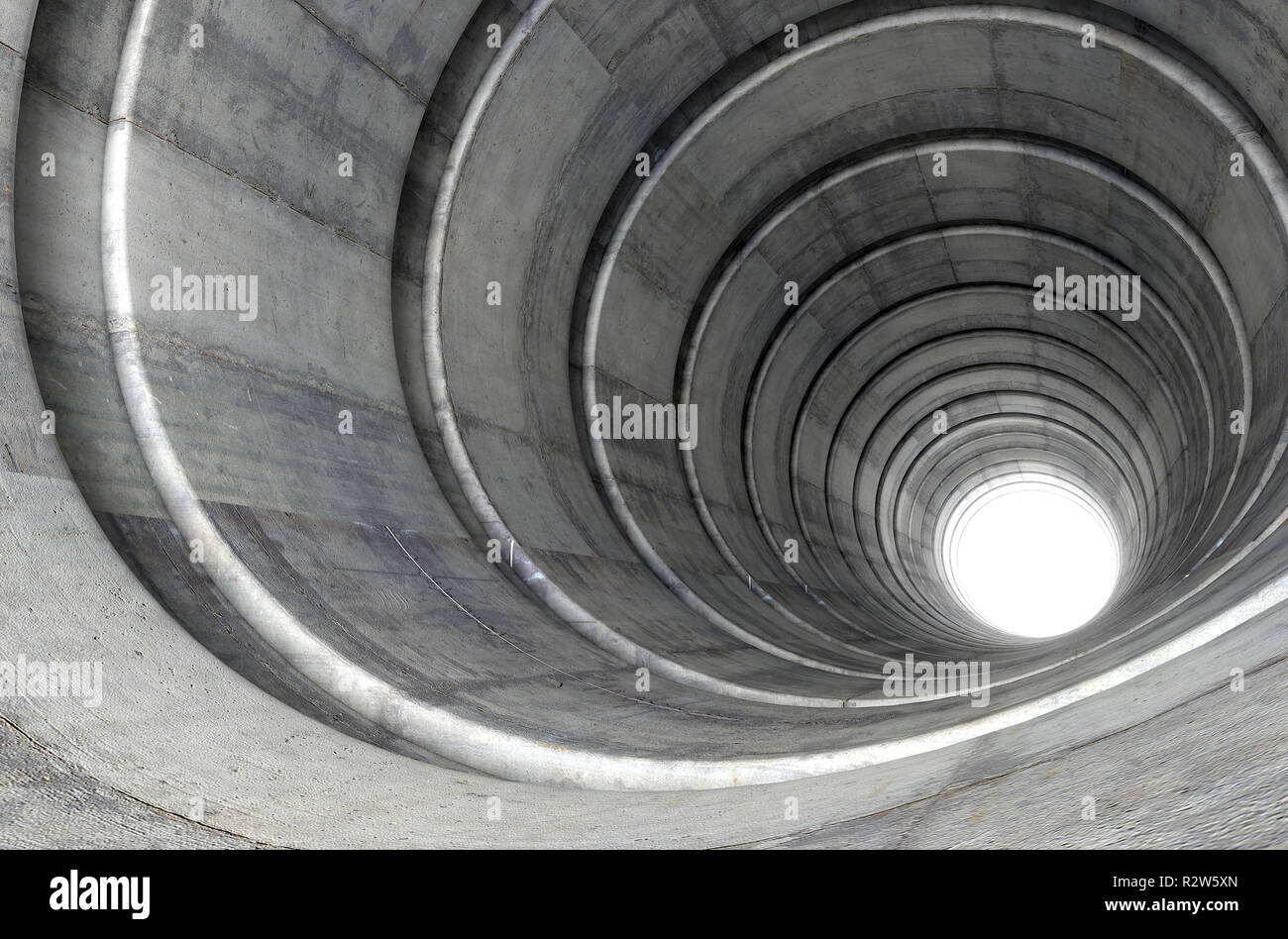 A look down a concrete tunnel made out of circular geometric shapes ...