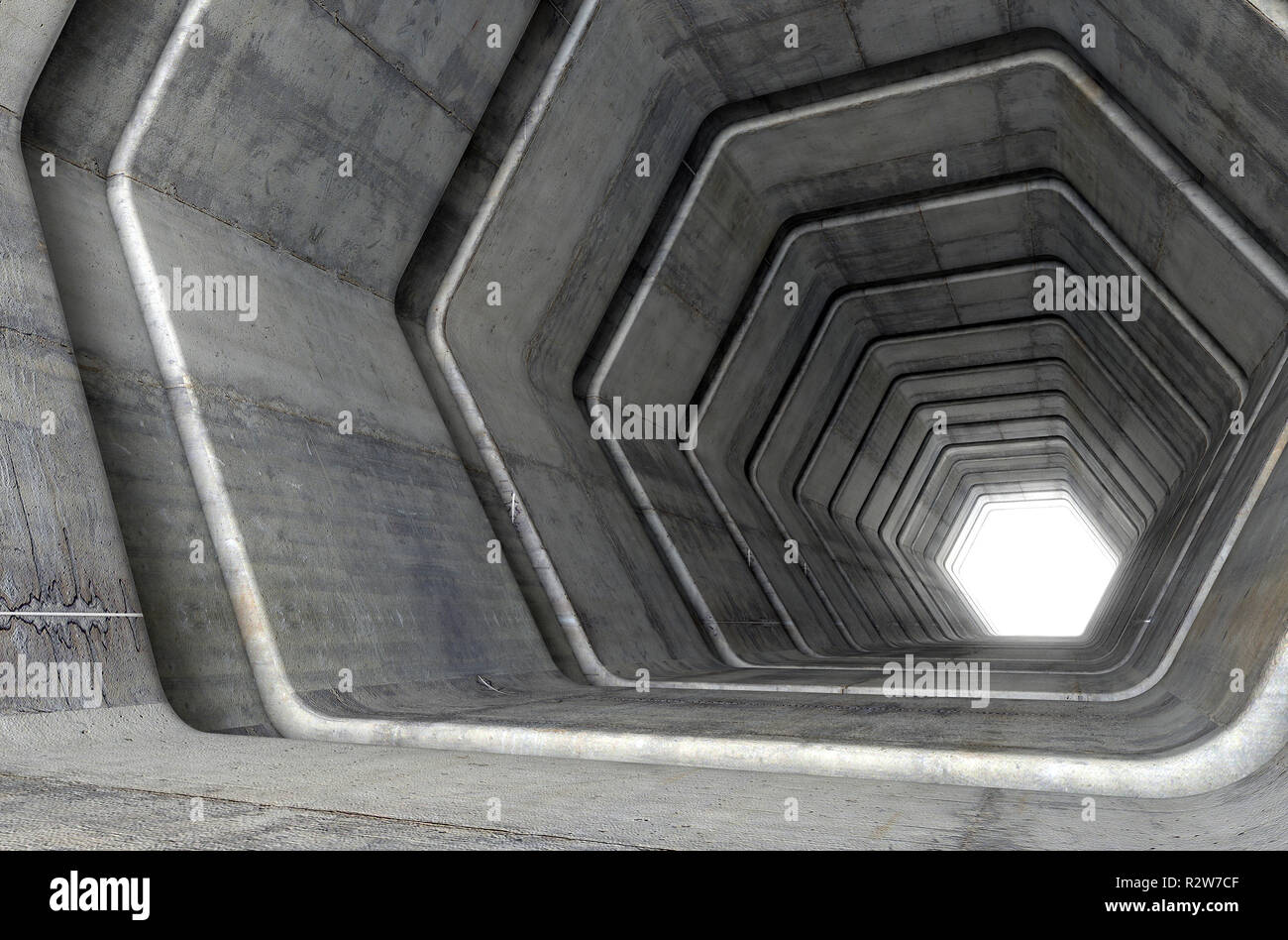 A look down a concrete tunnel made out of hexagonal geometric shapes ...
