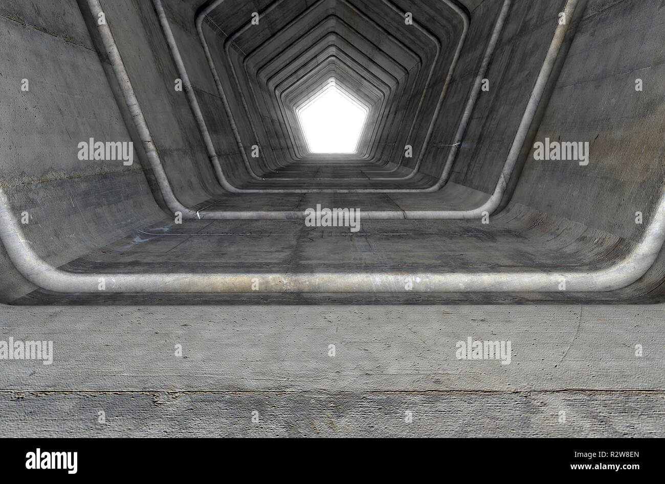 A look down a concrete tunnel made out of pentagonal geometric shapes ...