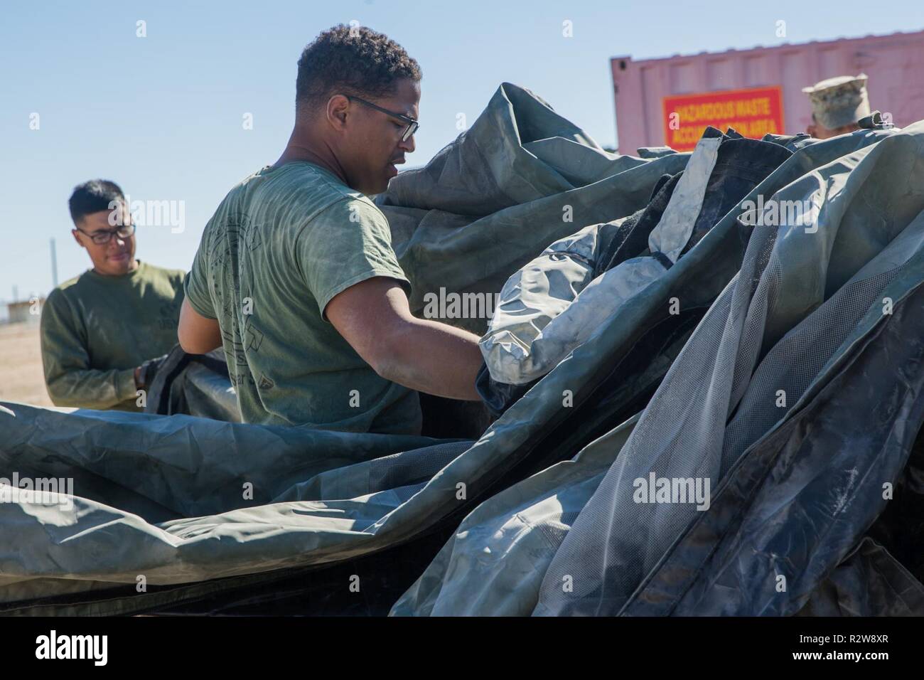 U.S. Marine Lance Cpl. Tyler Jefferies breaks down a tent during ...