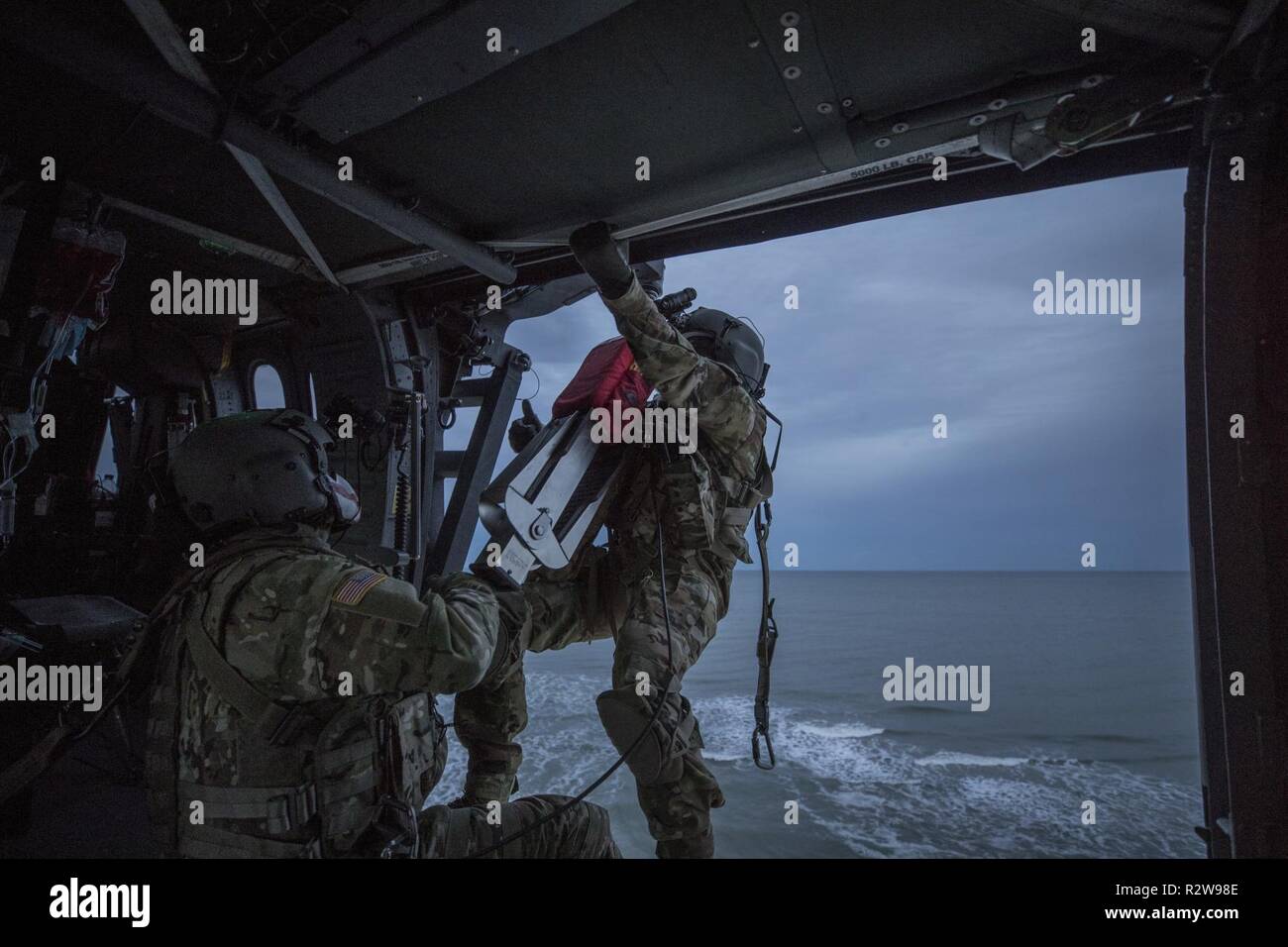 U.S. Army Sgt. Deven Scelfo, right, a flight medic, is assisted with ...