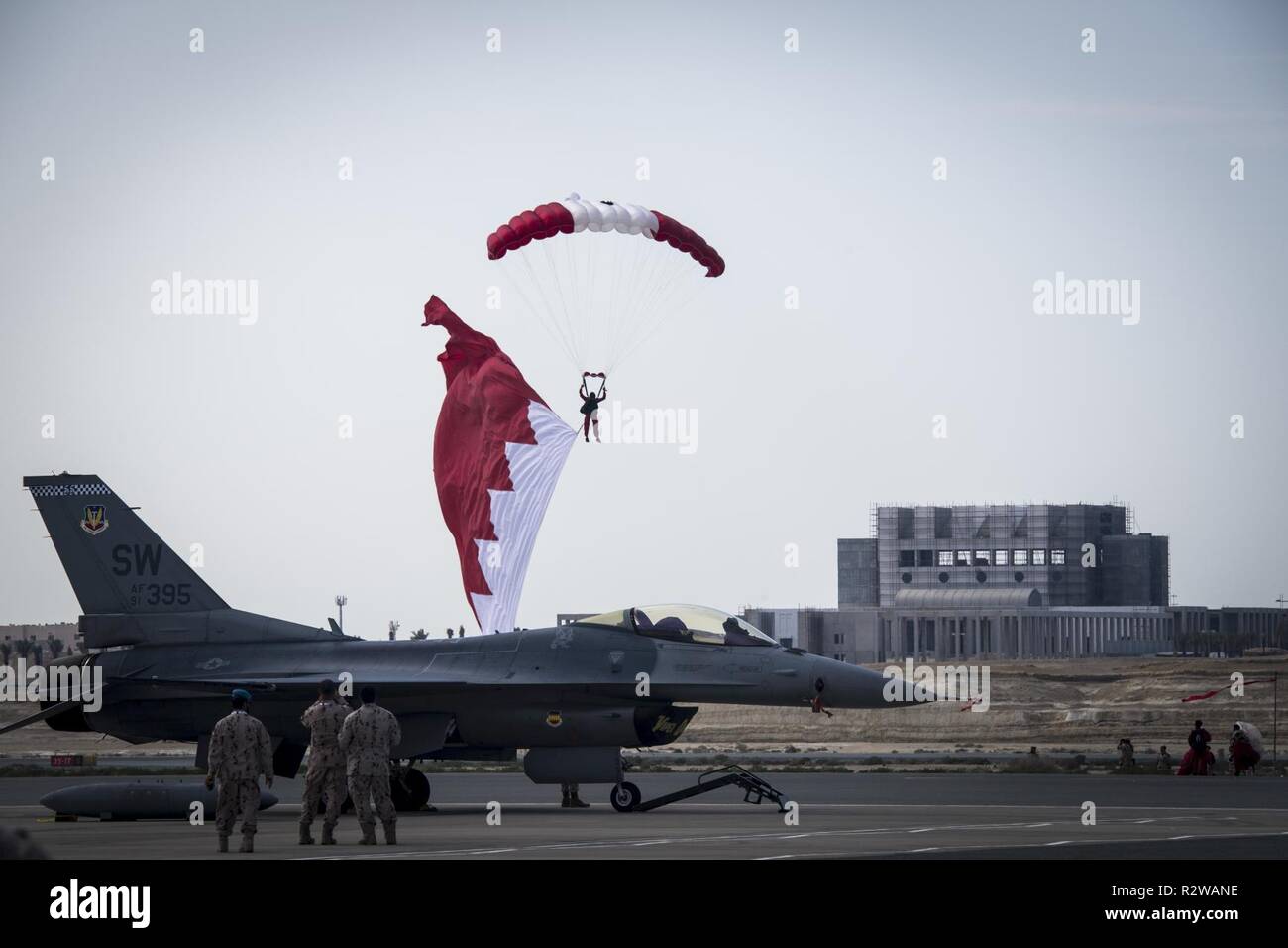 Bahrain Defense Forces parachute with the Bahrain flag above a U.S. Air ...