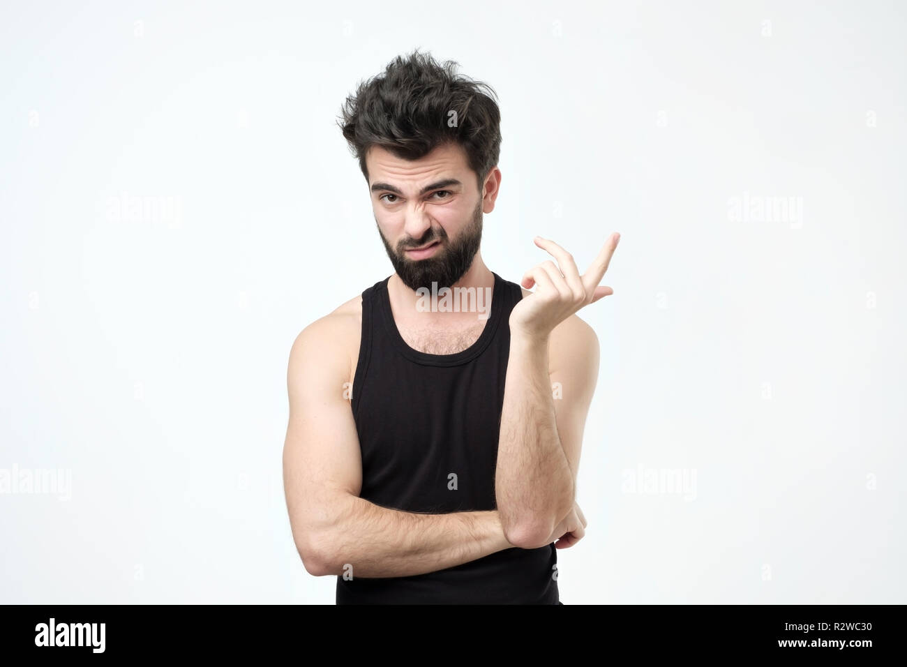 Angry man with shaggy hairstyle having skeptical and dissatisfied look ...