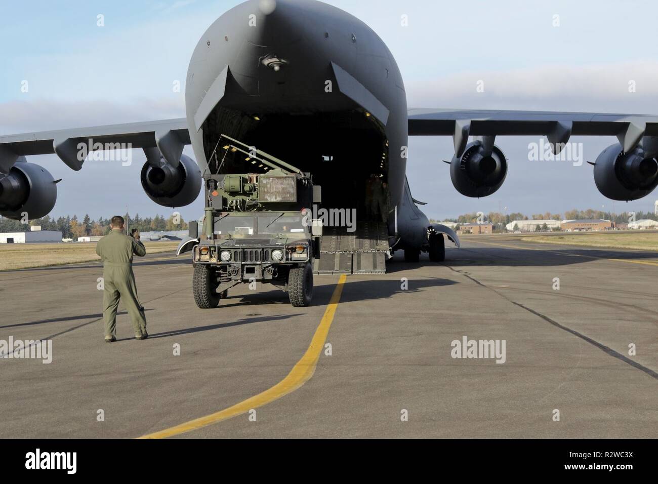 An Airman from the 62nd Airlift Wing loads a M1167 High Mobility ...