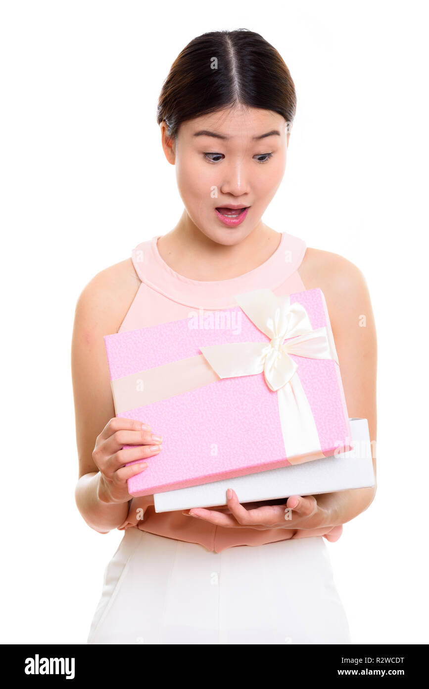 Young beautiful Asian woman opening gift box while looking surpr Stock ...