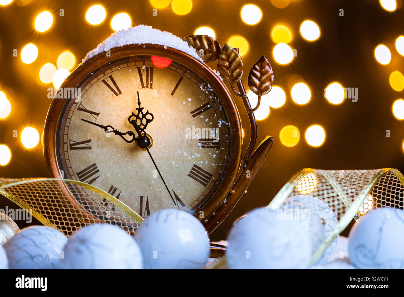 New Years clock and white balls covered with lights Stock Photo - Alamy
