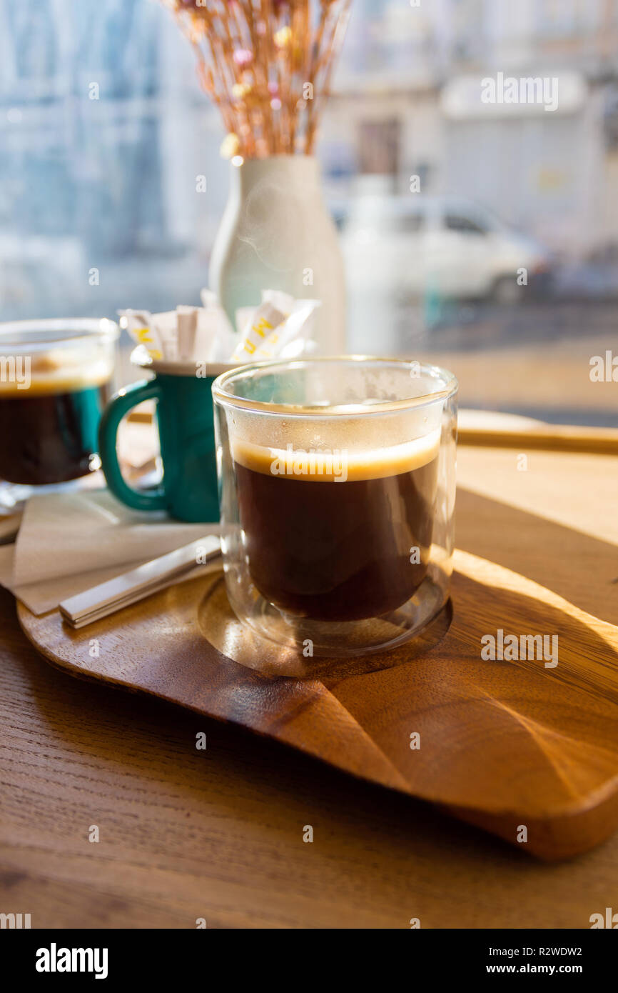 Morning cup of delicious flavored Americano on a wooden table near the ...